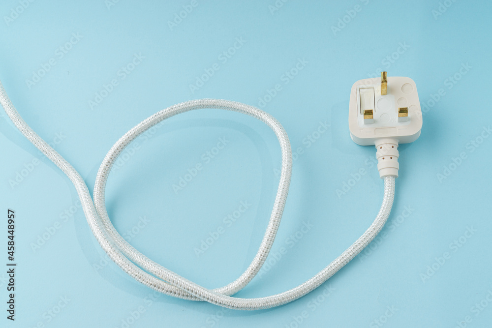 Three pin plug on light blue background with a copy space. Stock Photo ...