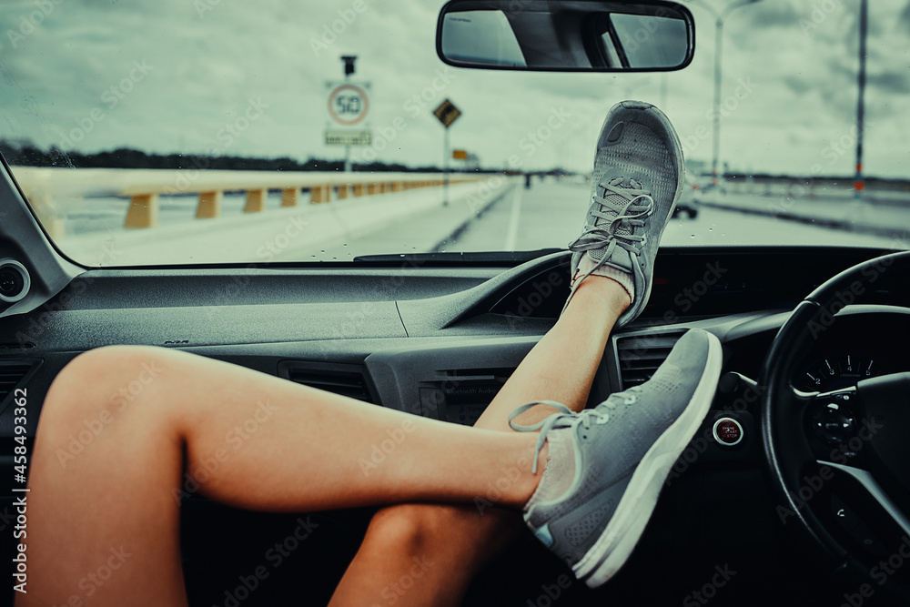 women sitting on passenger seat in car with feet on car dashboard ...