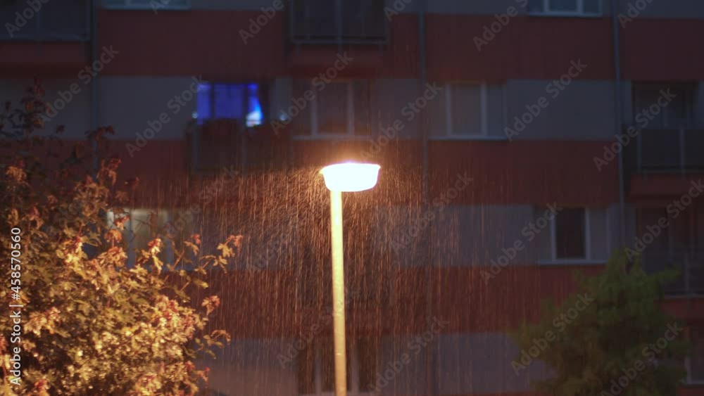 Night rainy weather. The lighting lantern shines at night. Raindrops ...
