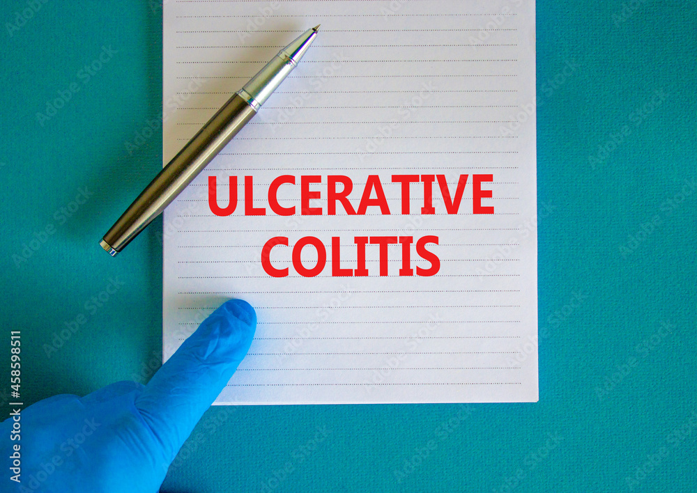 Ulcerative colitis symbol. White note with words Ulcerative colitis ...