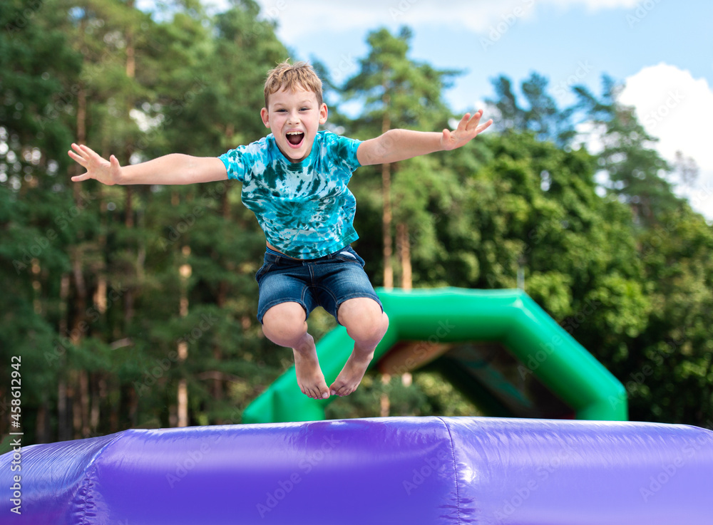 Child jumping on colorful playground trampoline. Kids jump in ...