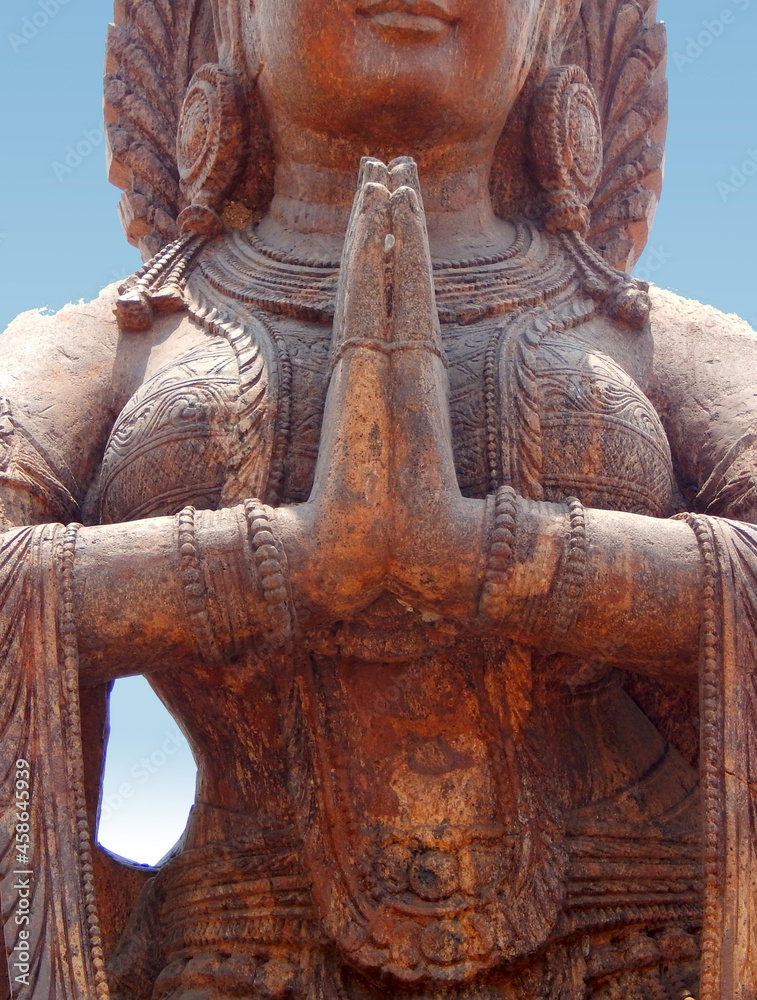 folded hands in greeting pose of an indian traditional woman statue in ...