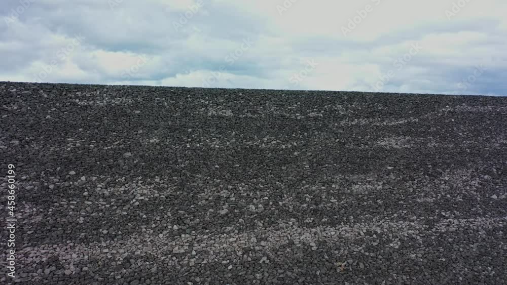 Massive rocky man-made landfill at Hardangervidda - Approaching wall of ...