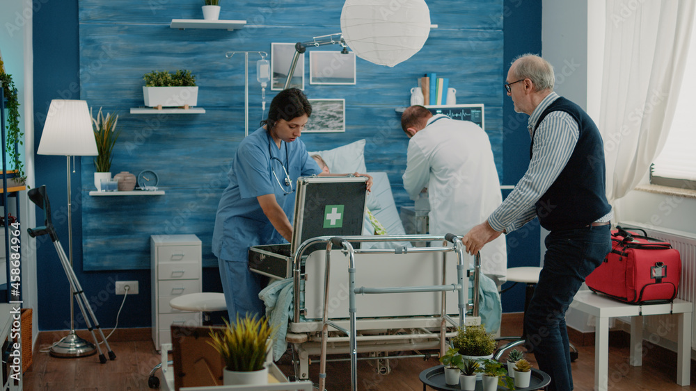 Worried man asking medical team to help sick old wife in nursing home ...