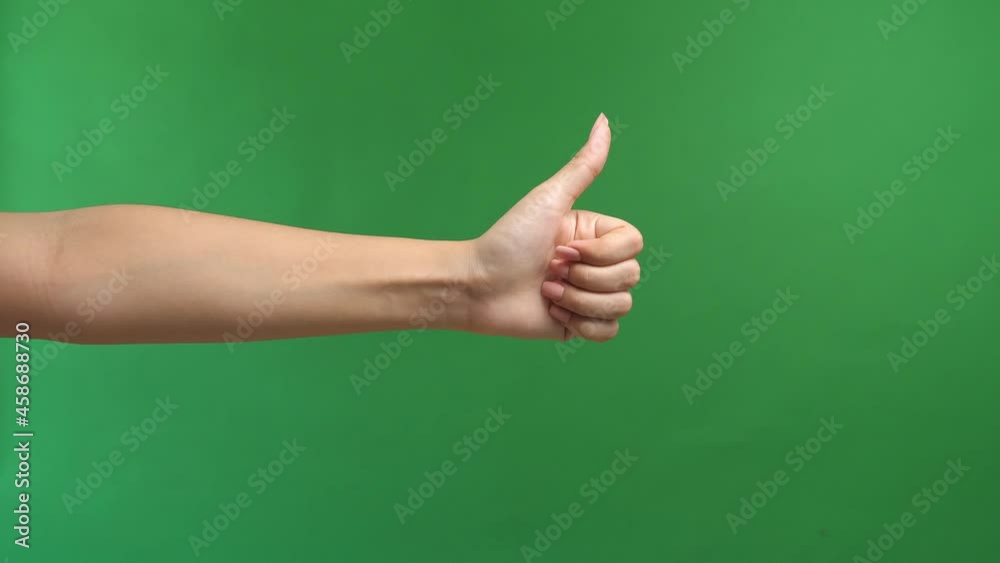 Closeup Of Female Hand Showing Thumbs Up Sign Against Green Screen ...