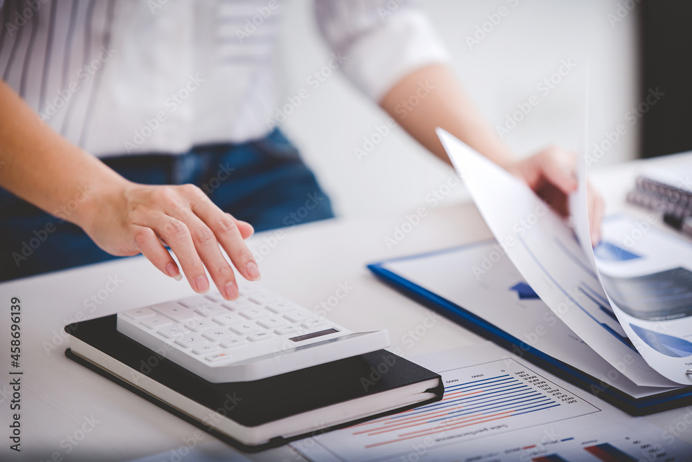businessman or accountant who are using a calculator to calculate ...