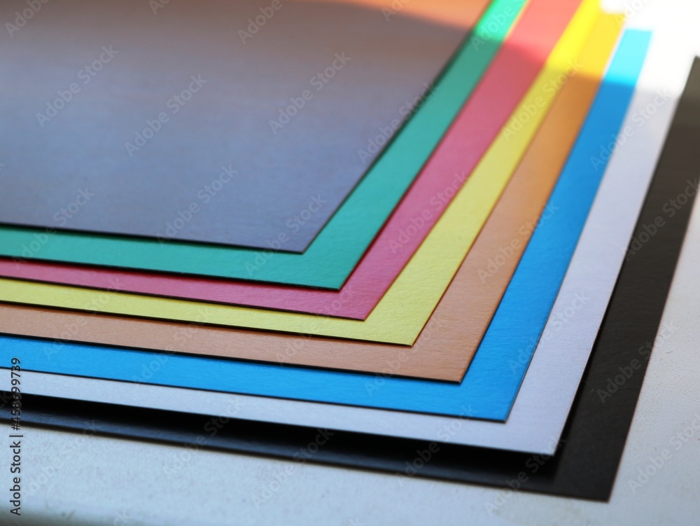 sheets of colored cardboard lying on the school desk, paper of ...
