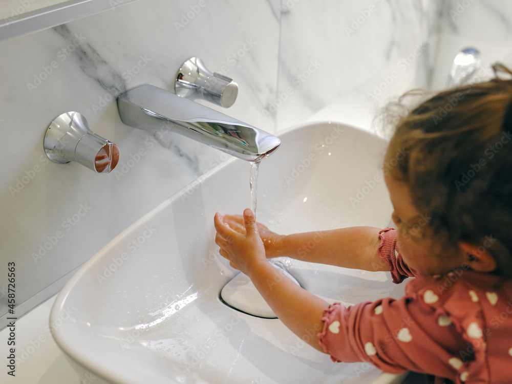 Baby girl washing hands Stock Photo | Adobe Stock