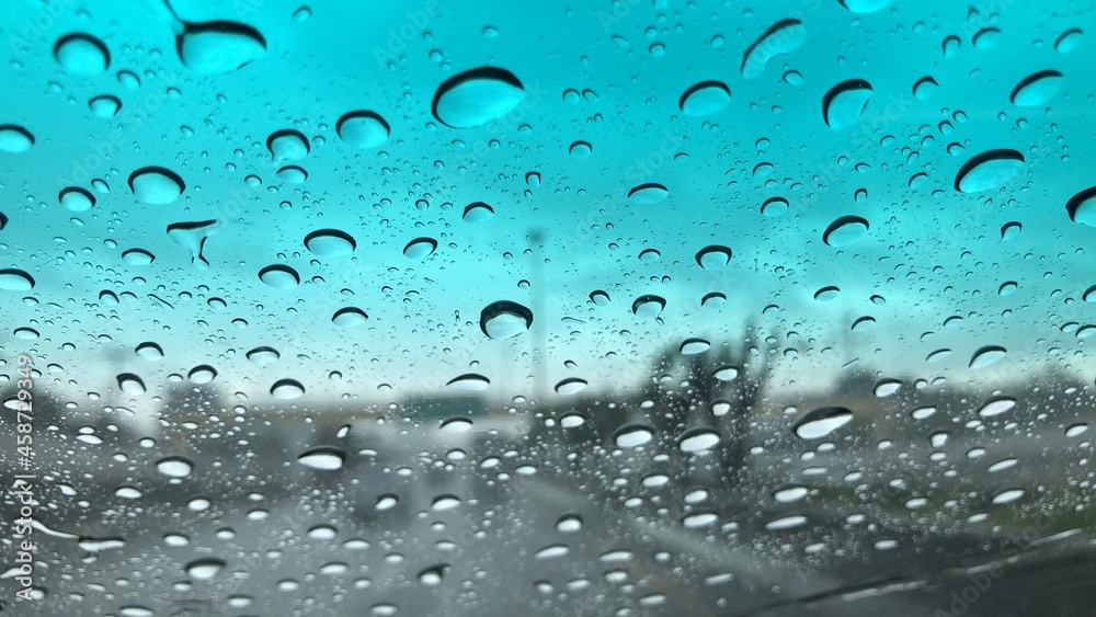 Rain falling on car windshield,drive car on street in city at heavy ...