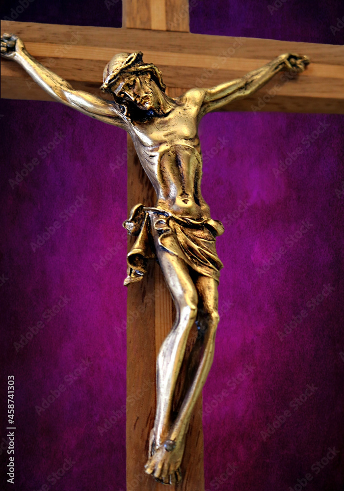Jesus on wooden cross on purple background Stock Photo | Adobe Stock