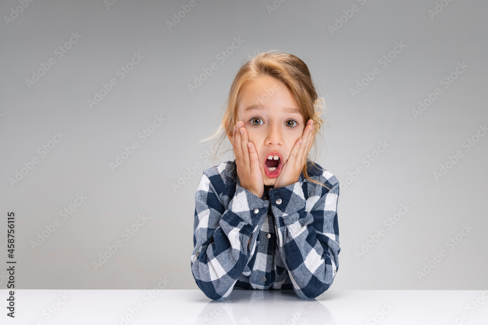 Portrait of beautiful little girl looking suprised, shocked isolated on ...