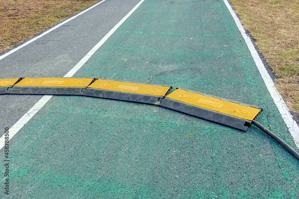 Black and yellow heavy plastic covers for people and vehicle to cross ...