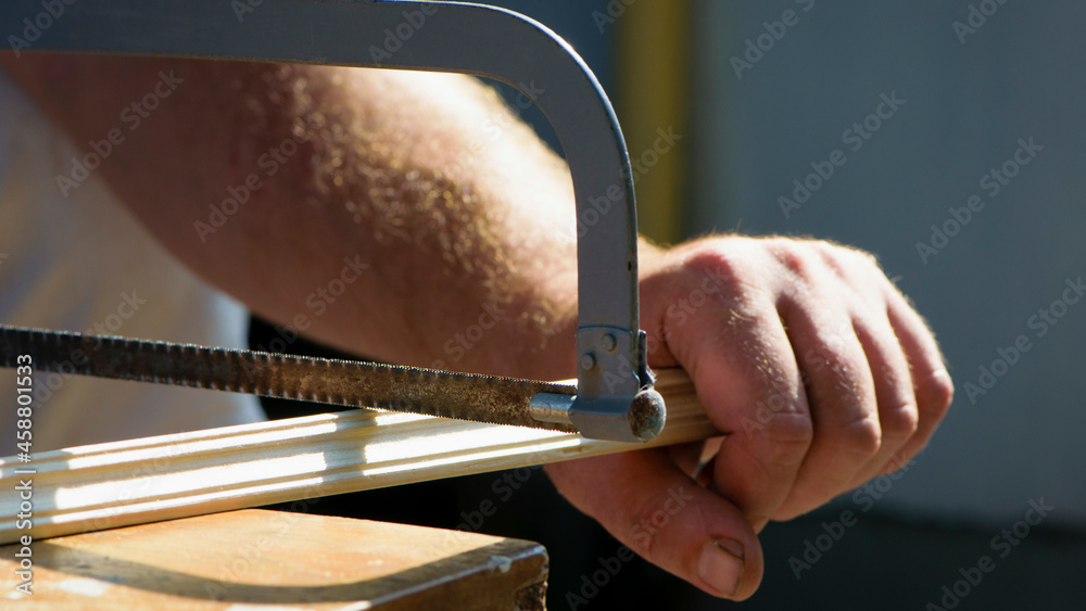 Hand saw with hardened teeth isolated. saw in hand, hacksaw at work ...