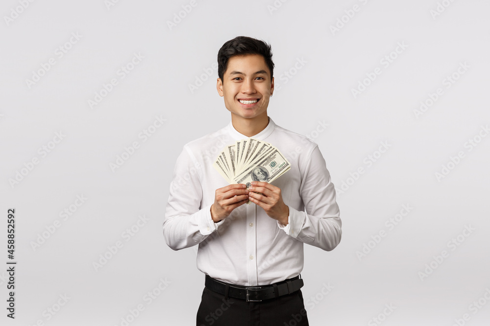 Look at that cash. Handsome happy and rich young asian guy ready spend ...