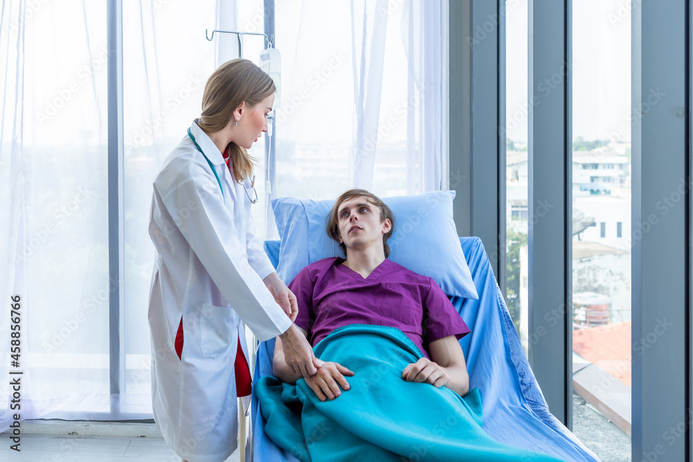 female doctor hold the leg to heal the illness to a man patient on bed ...