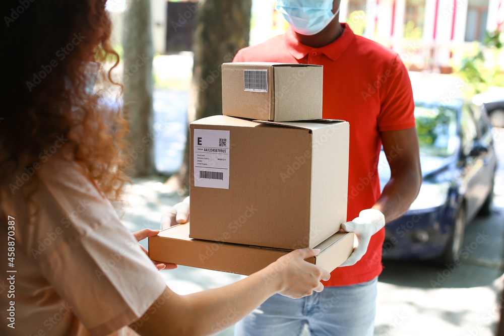 Customer receiving parcel from delivery man Stock Photo | Adobe Stock