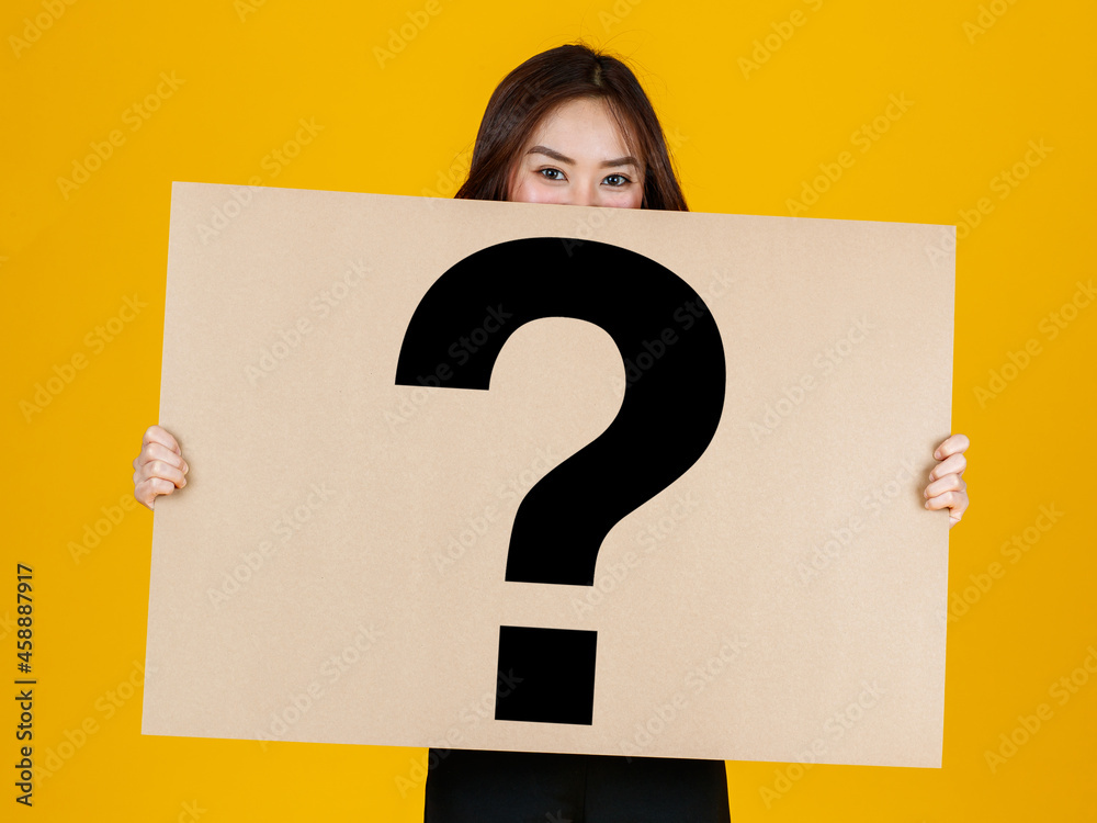 Young happy Asian women holding huge cardboard sign with question mark ...