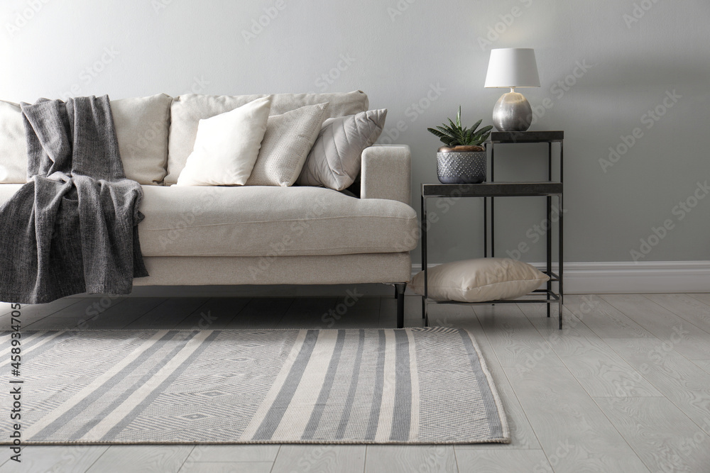 Living room interior with comfortable sofa and stylish rug Stock Photo ...