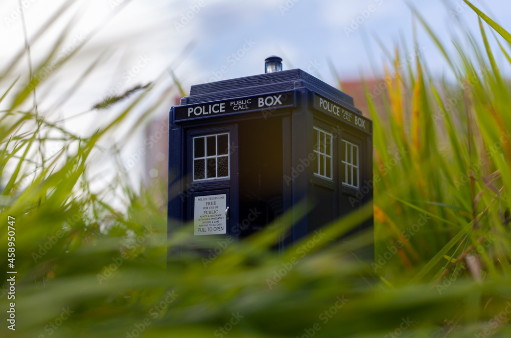 Blue police box as Tardis from Doctor Who in green grass. Time machine ...