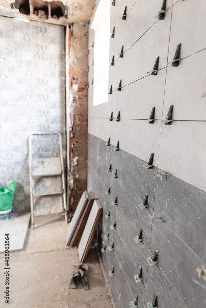 detail of tiles placed in the bathroom with a separator between them ...