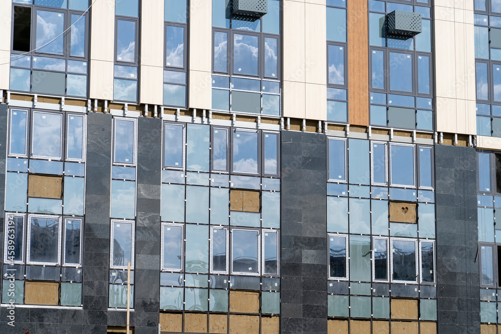 Residential building under construction with attached ready-made facade ...
