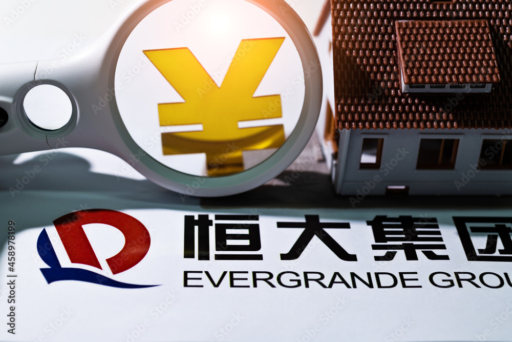 China Evergrande Group logo with small house model, magnifier and ...