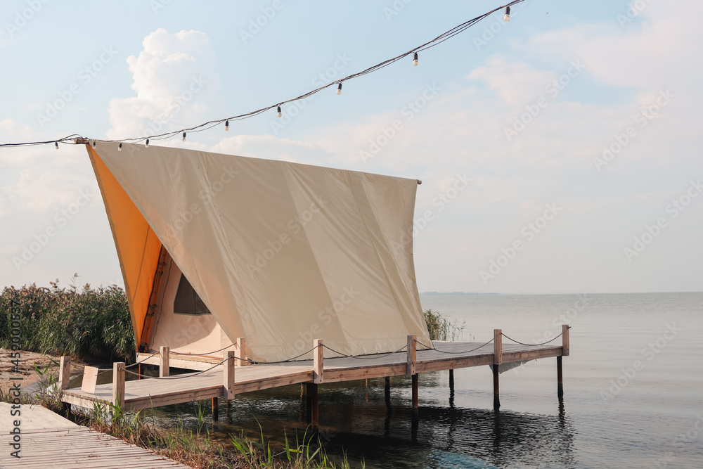Glamping tent in the forest. Luxury tent sea view. Nature green tourism ...