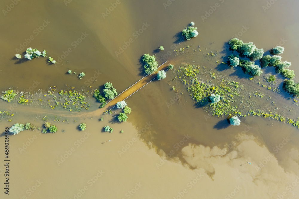 Abstract aerial view of flooded pedestrian bridge and walking path in ...