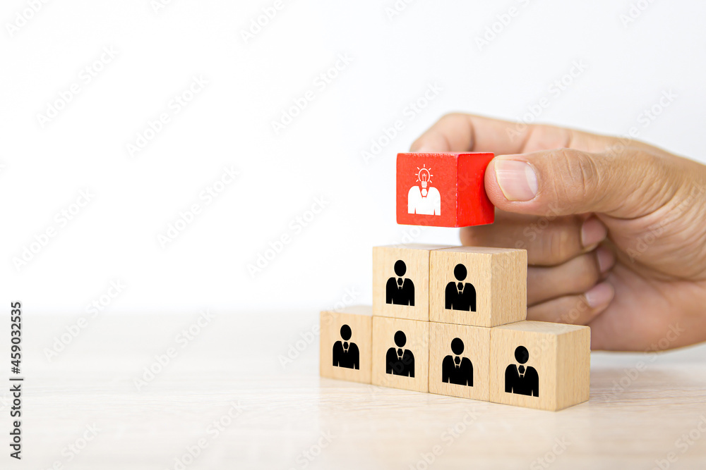 Hand choose human with head light bulb icon on cube wooden block stack ...