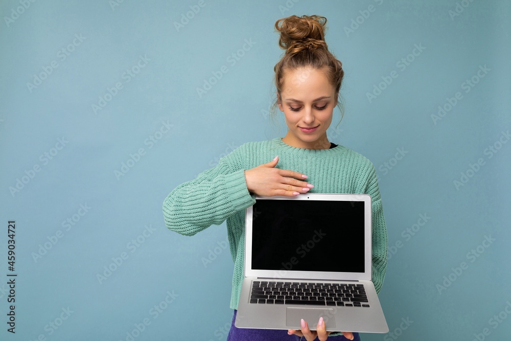 beautiful dark blond young woman with gathered curly hair looking down ...
