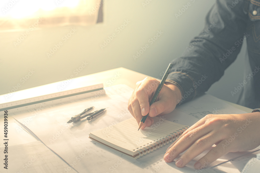Architect working on blueprint. Architects workplace - architectural ...