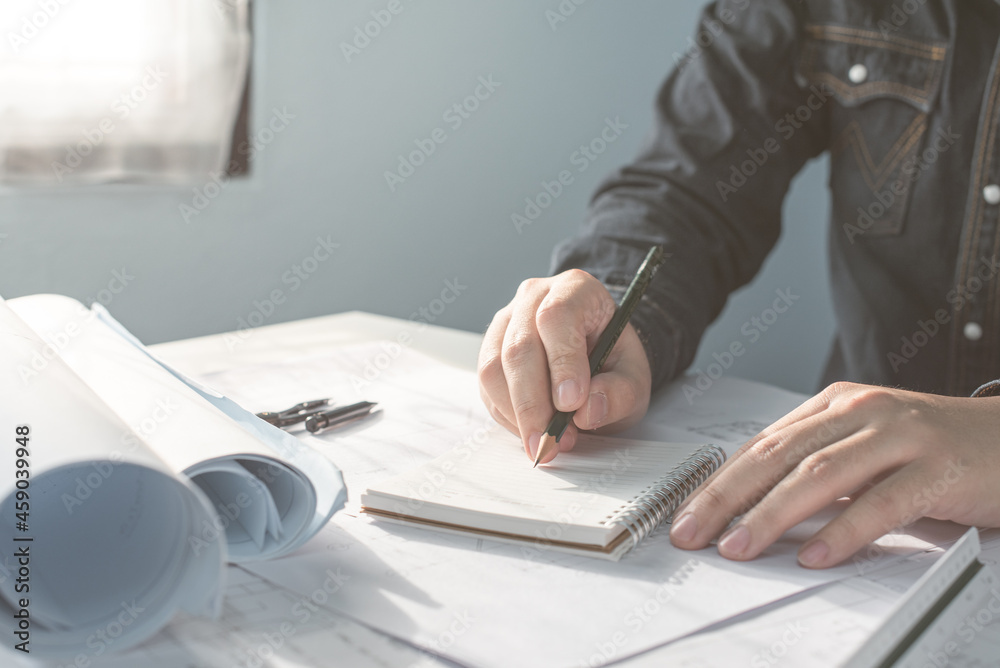 Architect working on blueprint. Architects workplace - architectural ...