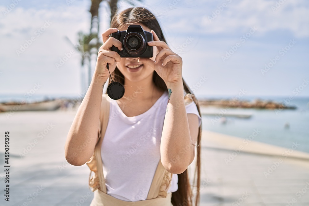 Young chinese girl smiling happy using camera at the promenade. Stock ...