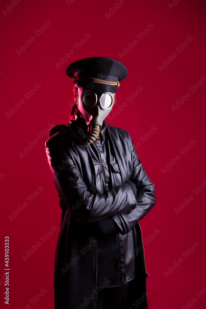 fantastic Nazi in black leather clothes and a cap with a gas mask on ...