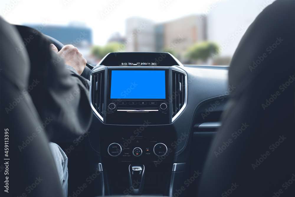 Mockup, Man driving a modern car in the city with blank blue screen ...