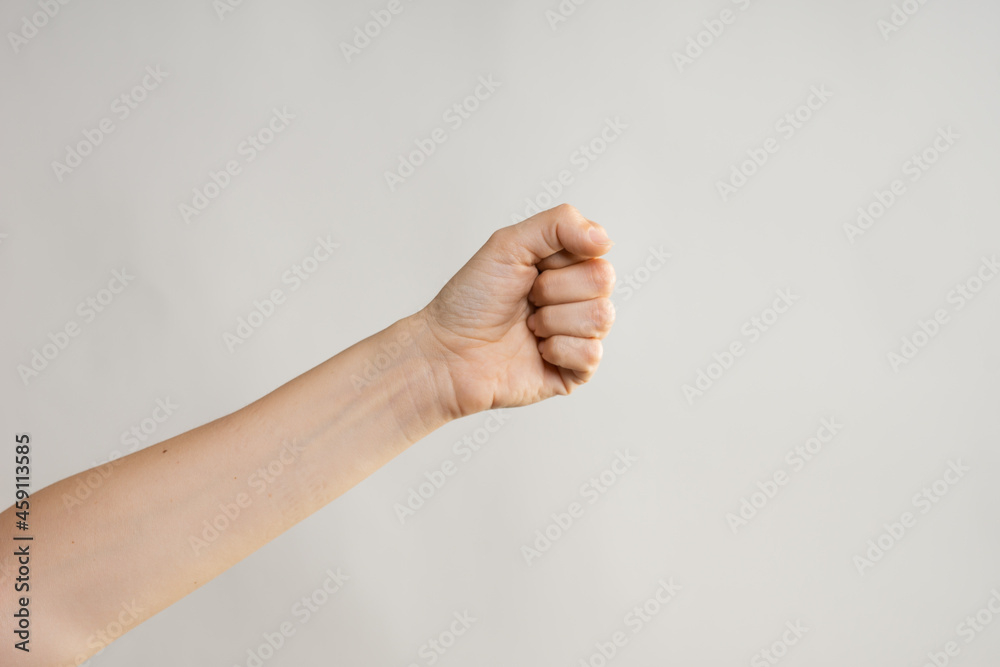 Hand gestures. Hand gestures. woman's fist stretches up, a symbol of ...