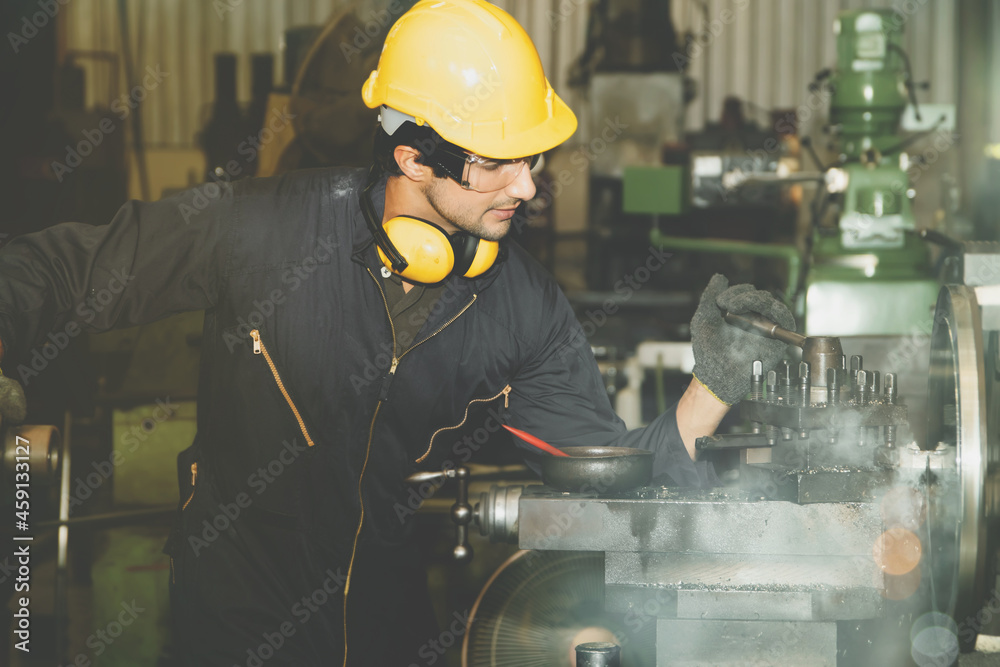 Turning technician controls the production of lathes on the machine ...