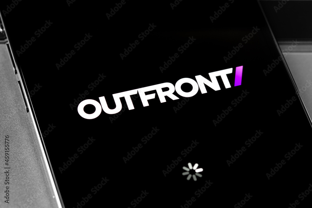Outfront Media logo on screen smartphone iPhone closeup. Outfront Media ...