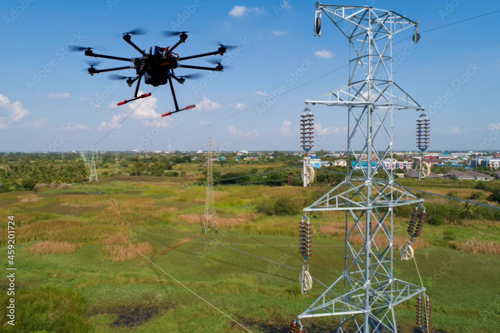 Drone stringing transmission lines for installation of electrical high ...