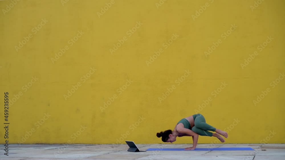 Positive young woman having first remote yoga lesson trying to make ...