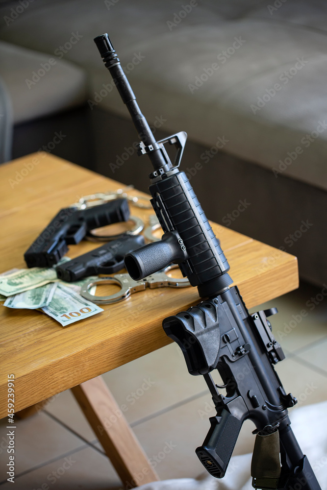 Modern automatic high powered rifle , police handcuffs, semi automatic ...
