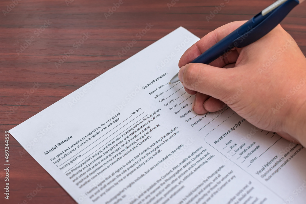 Signing a model release document, backed by legal rights for permission ...