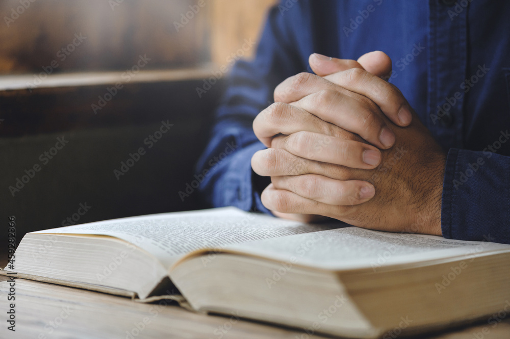 Foto de Christian man hand praying to god with the bible. believe in ...