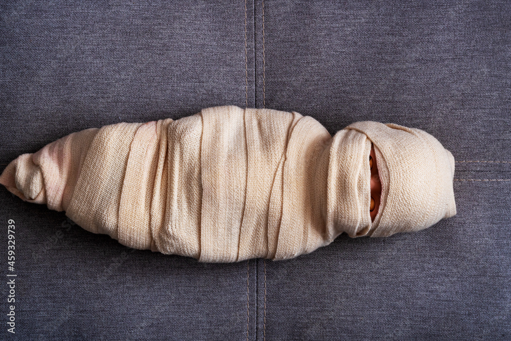 The man is wrapped in a cloth. The body is shrouded in a veil. The ...