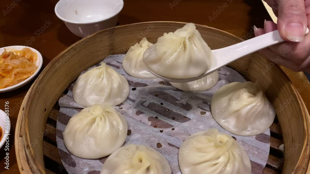 Using chopsticks for eating dumplings in a restaurant. Traditional ...