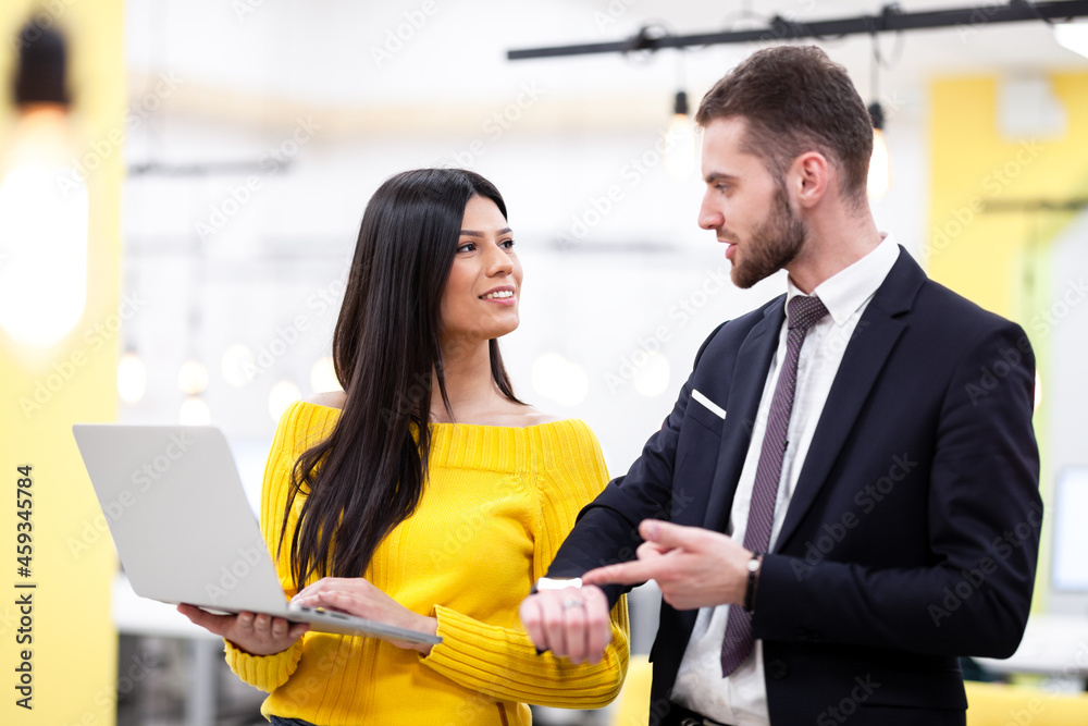 Beautiful Caucasian dark haired girl in yellow posing with businessman ...