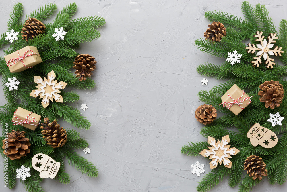 Christmas decorations and fir tree branch and gift boxon dark table ...