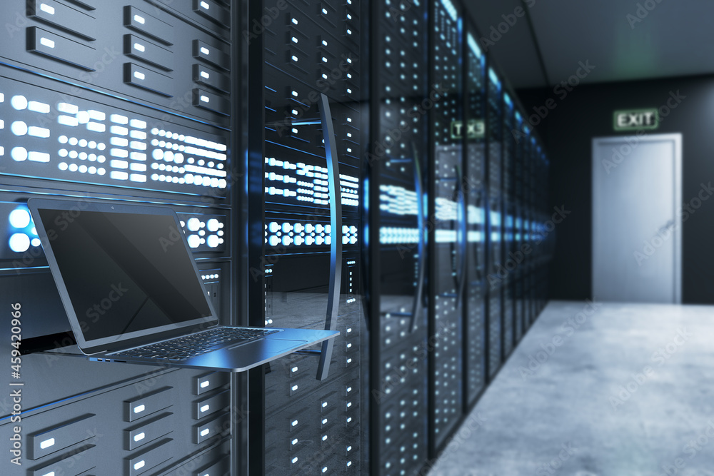 Empty laptop computer in illuminated server room interior. Internet ...