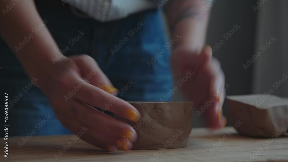 Cut a piece of clay with a special string. Pottery studio, creative ...