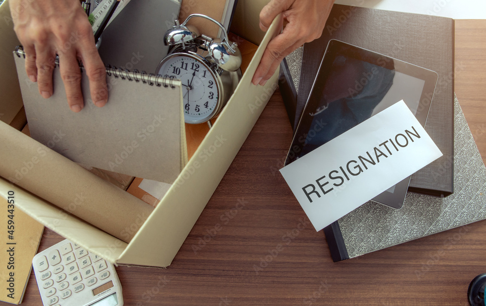 Office worker prepare resignation letter and collect office tools and ...